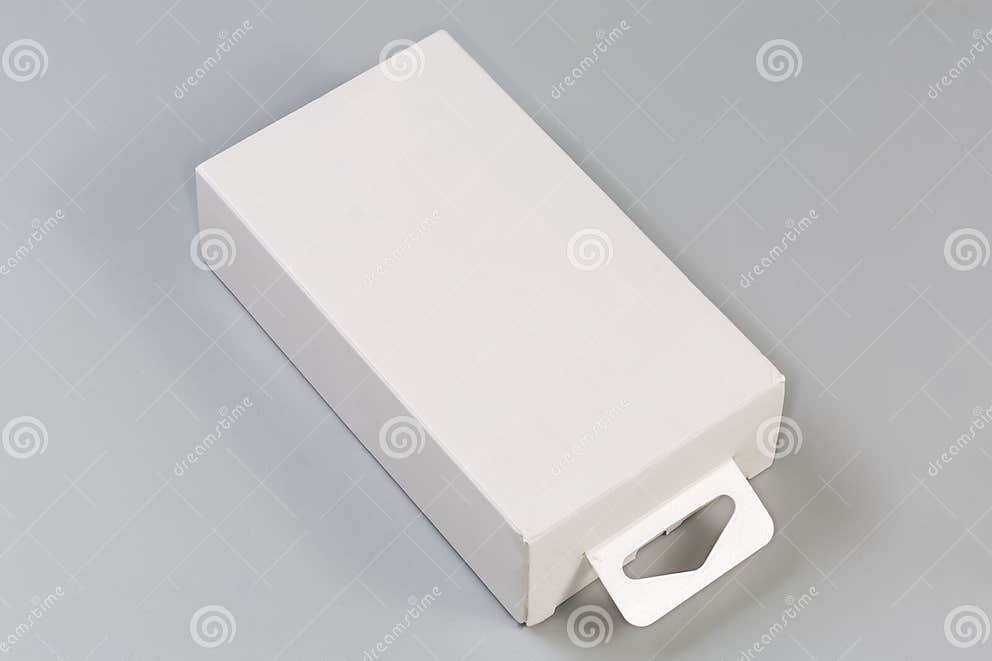 White Rectangular Cardboard Hang Tab Packing Box on Gray Surface Stock ...