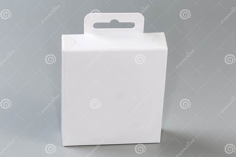 White Rectangular Cardboard Hang Tab Packing Box on Gray Surface Stock ...