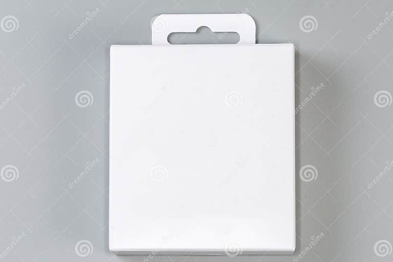 White Rectangular Cardboard Hang Tab Packing Box on Gray Surface Stock ...