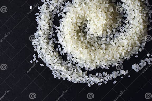 White Rice Curled into a Curl on a Black Background Stock Image - Image ...