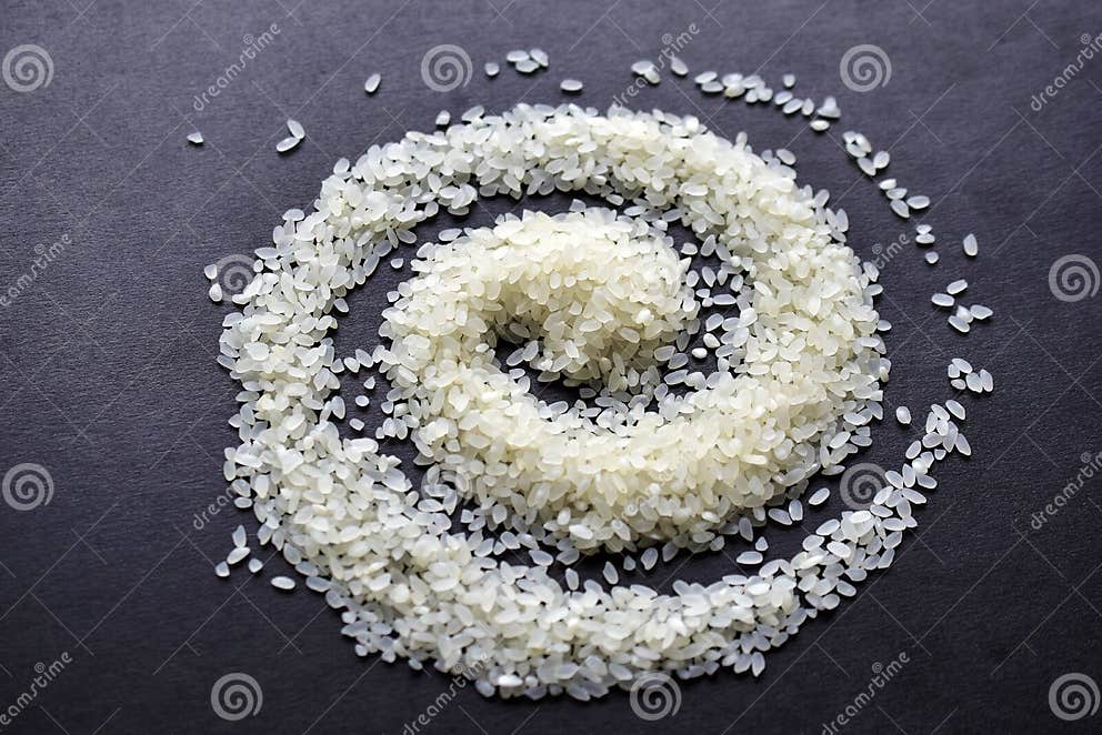 White Rice Curled into a Curl on a Black Background Stock Image - Image ...