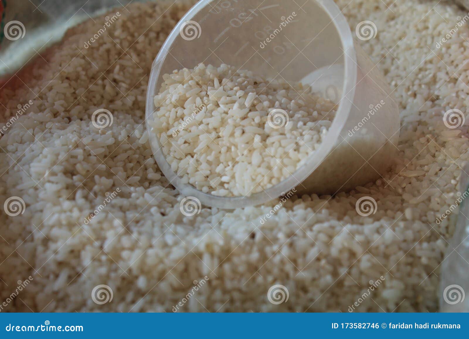 White Rice with Measured daily Dose in the Plastic Cup Stock Photo ...