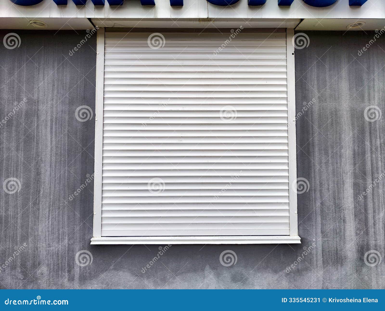 A White Rolling Shutter is Closed, Obstructing the Window of a Building ...