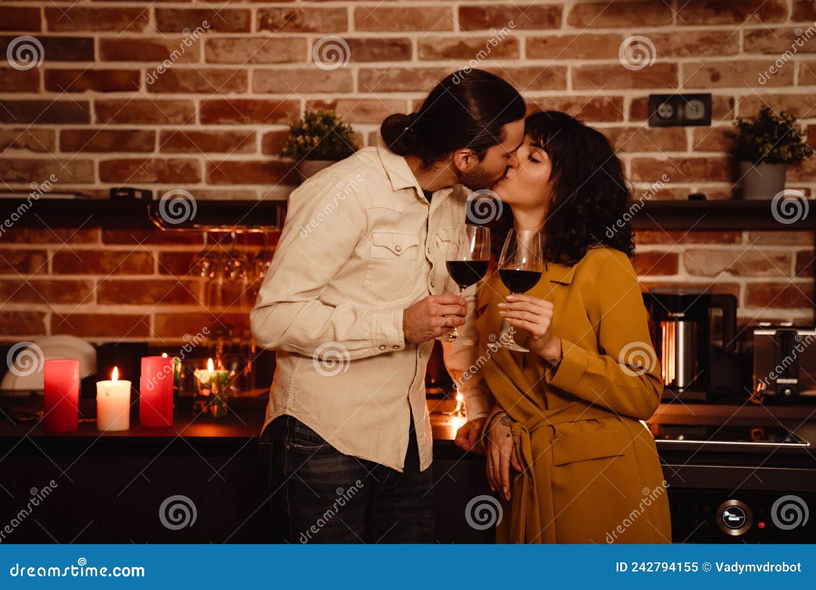 White Romantic Couple Kissing while Drinking Wine at Home Stock Image ...