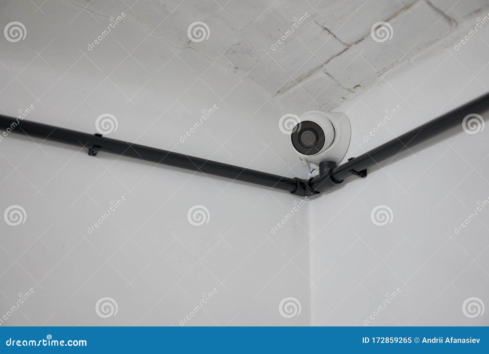 White Round Cctv Camera Installed in the Corner on a White Wall Stock ...