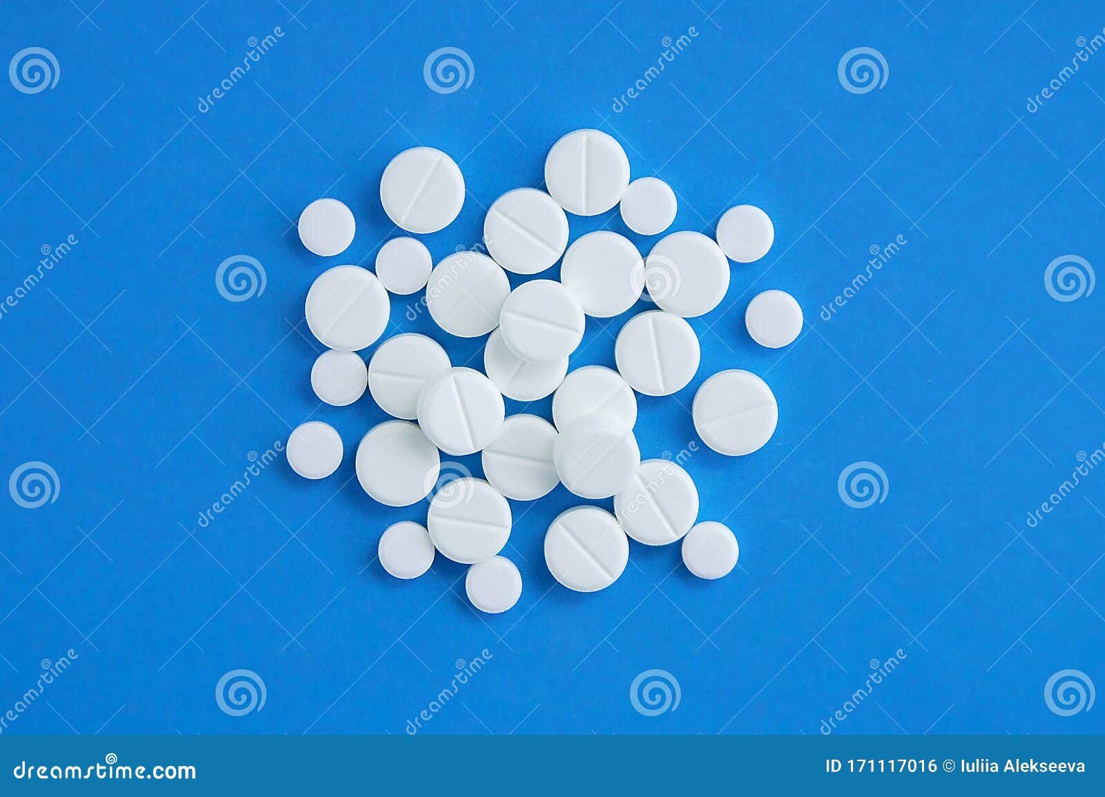 White Round Pills on a Blue Background. Stock Photo - Image of drug ...
