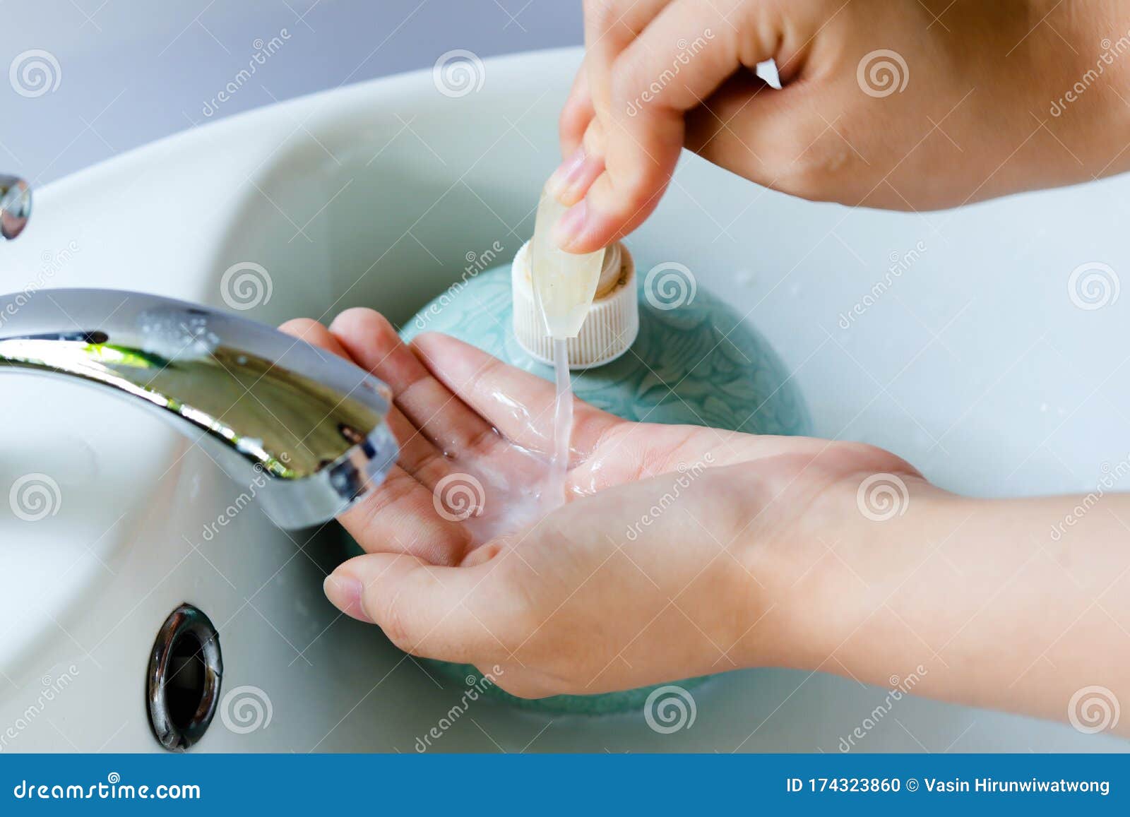 White Round Shape Ceramic Sinks and Hands Washing with Liquid Soap ...