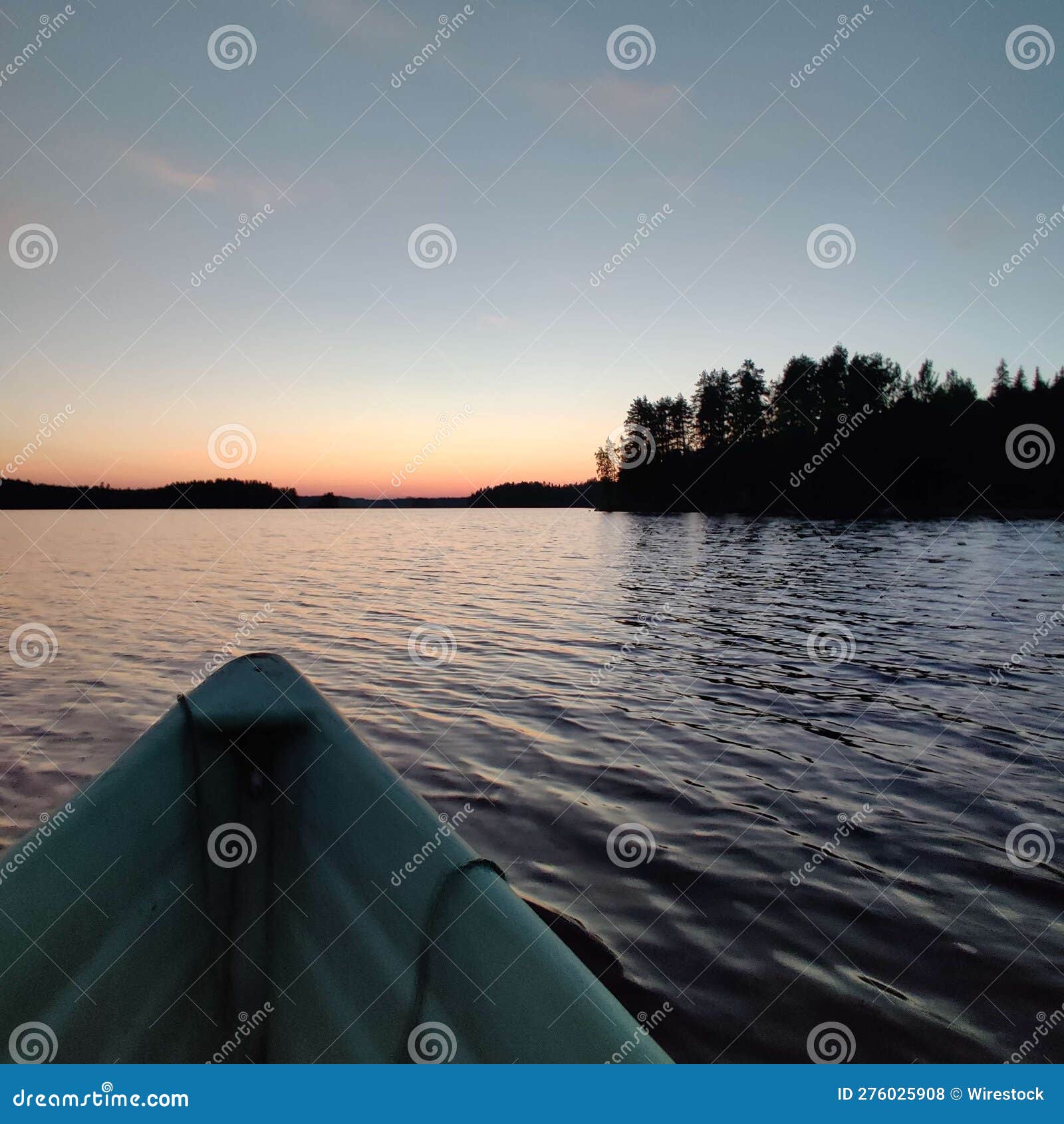 White Sailboat in the Foreground of an Idyllic Lake Setting Stock Photo ...