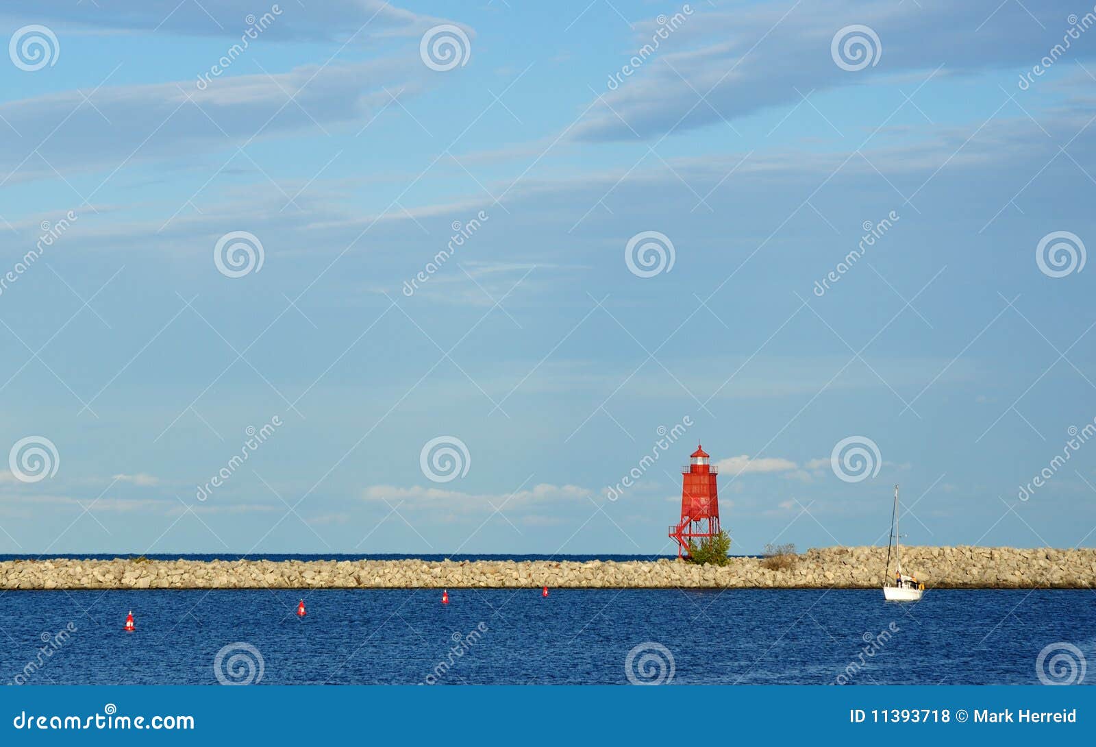 White Sailboat and Red Lighthouse in Harbor Stock Photo - Image of ...