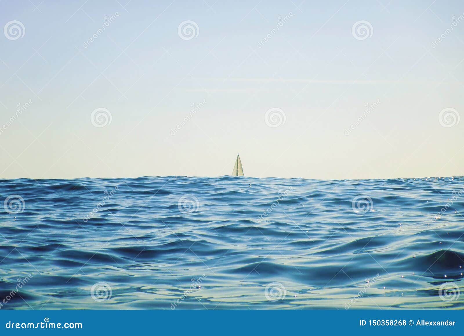 White Sailing Boat Sailing on the Horizon, Open Blue Sea Stock Photo ...