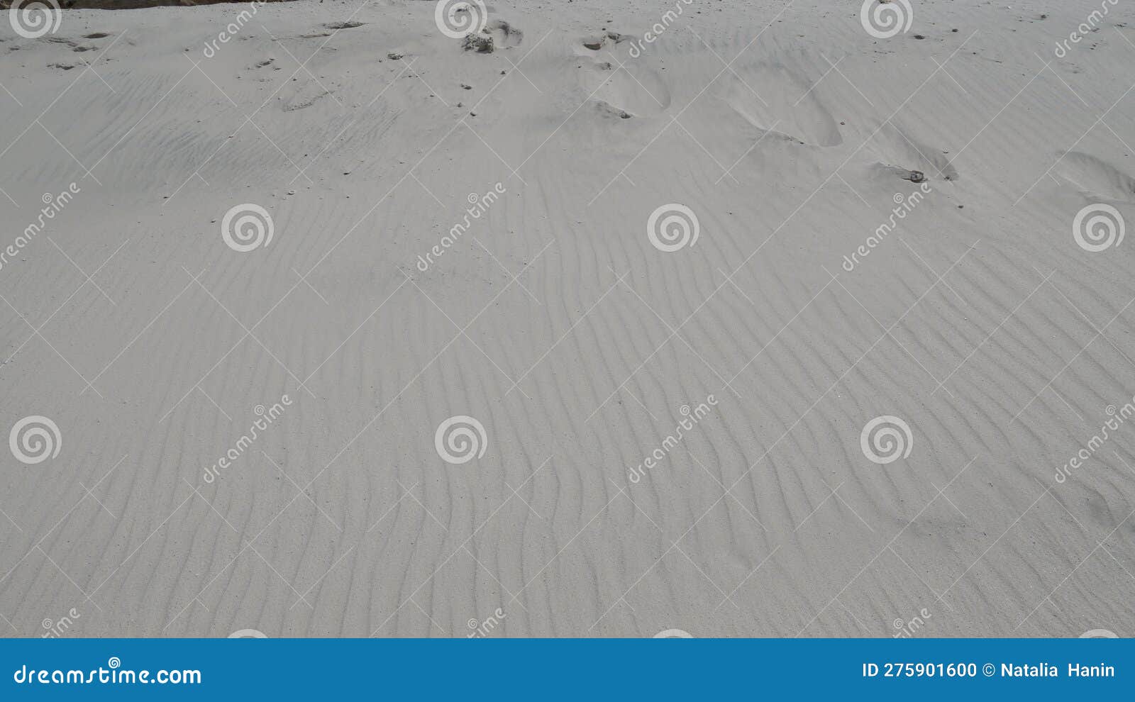 White Sand Dune with Ripples and Wisps of Sand Being Blown Off the ...