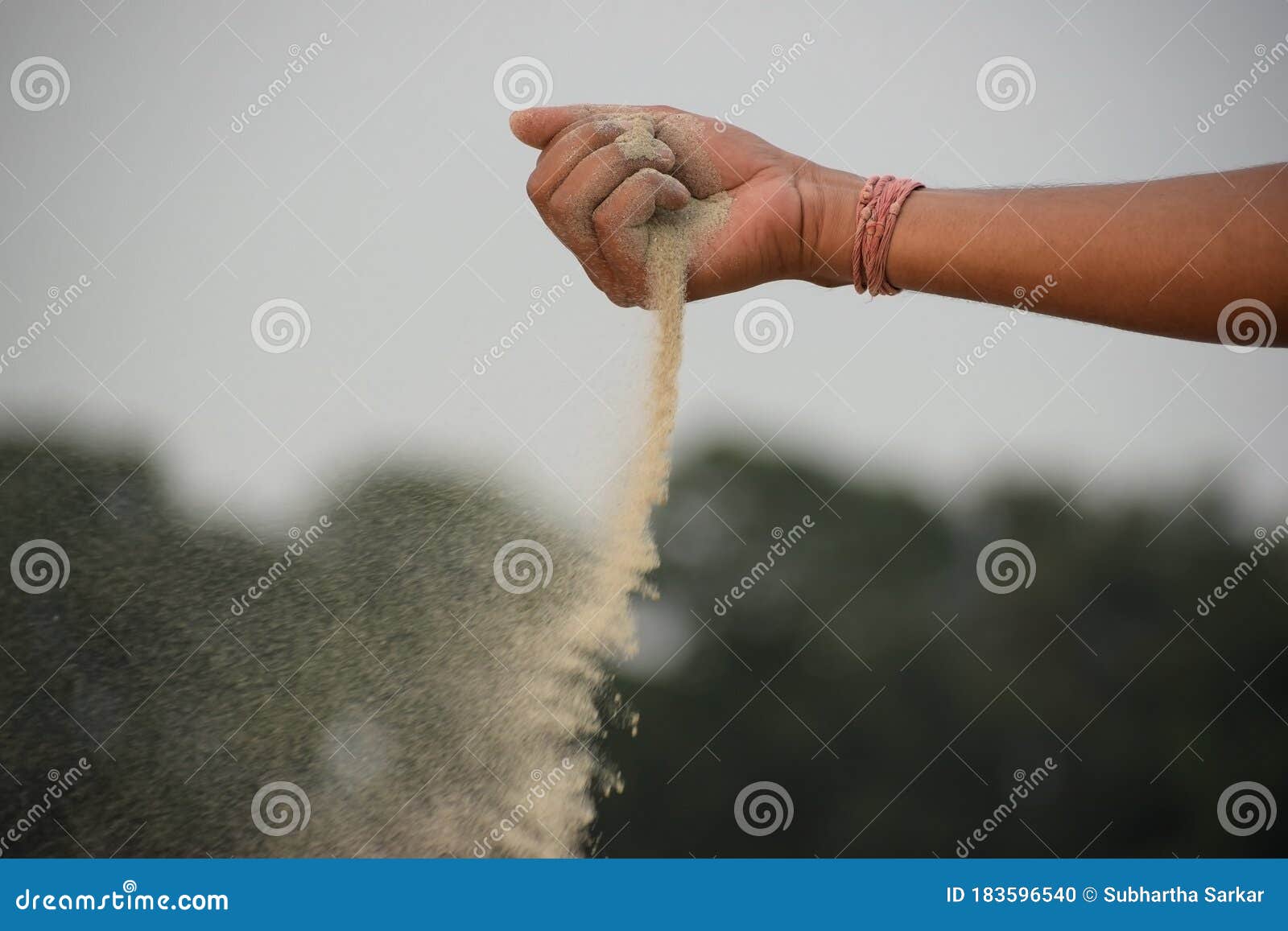 White Sand Falling from Hand in Outdoor and the Sand Particles are ...