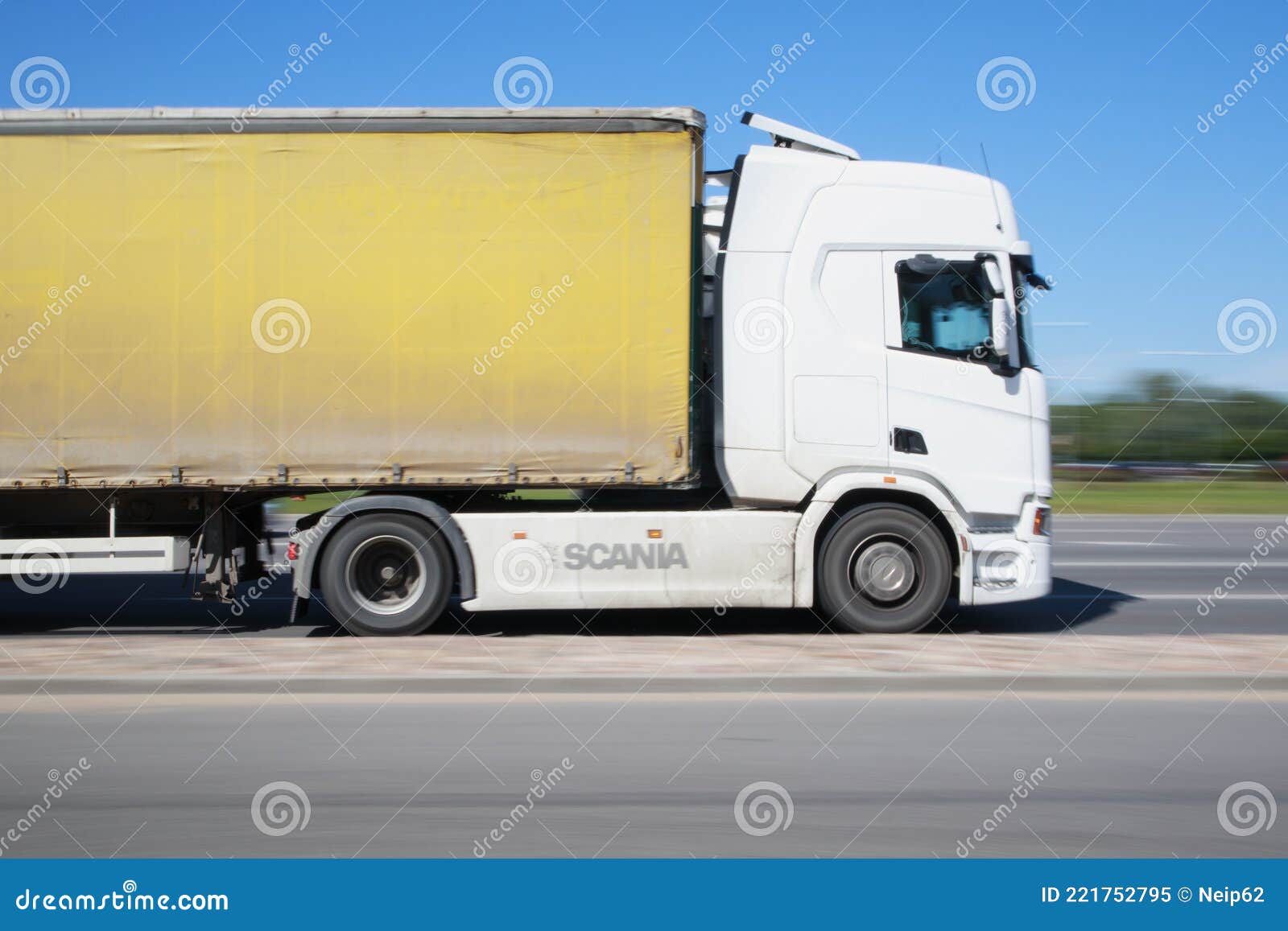 A White Scania S Pulls a Semi-trailer Down the Street. Side View ...