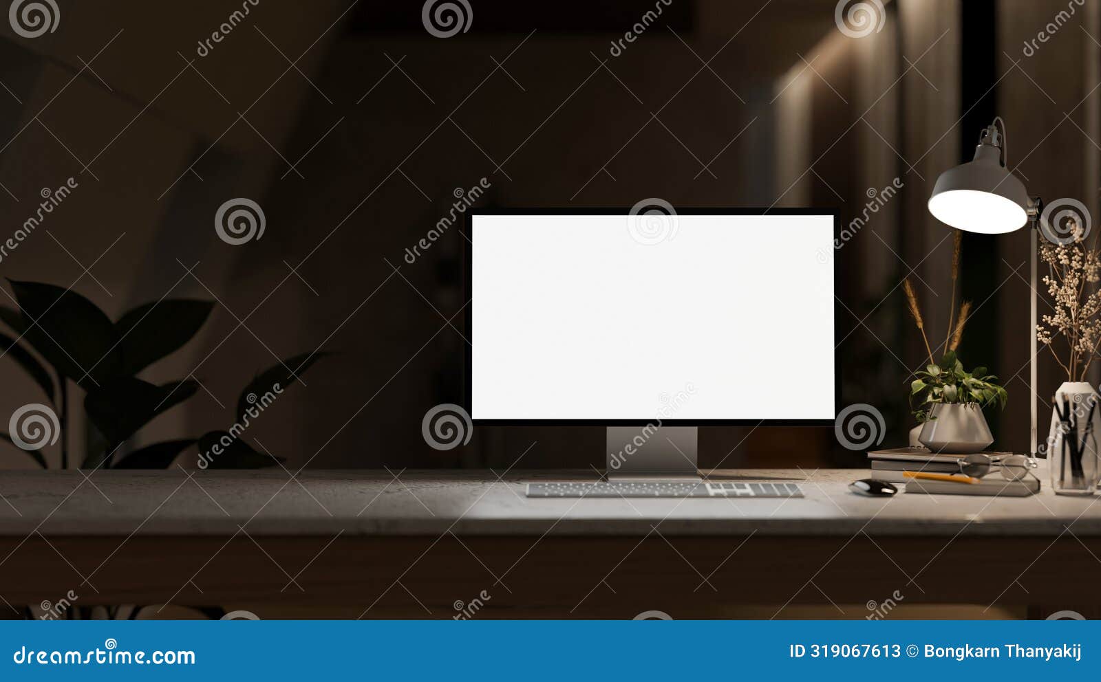 A White-screen Computer Mockup and a Dim Light from a Lamp on a Table ...