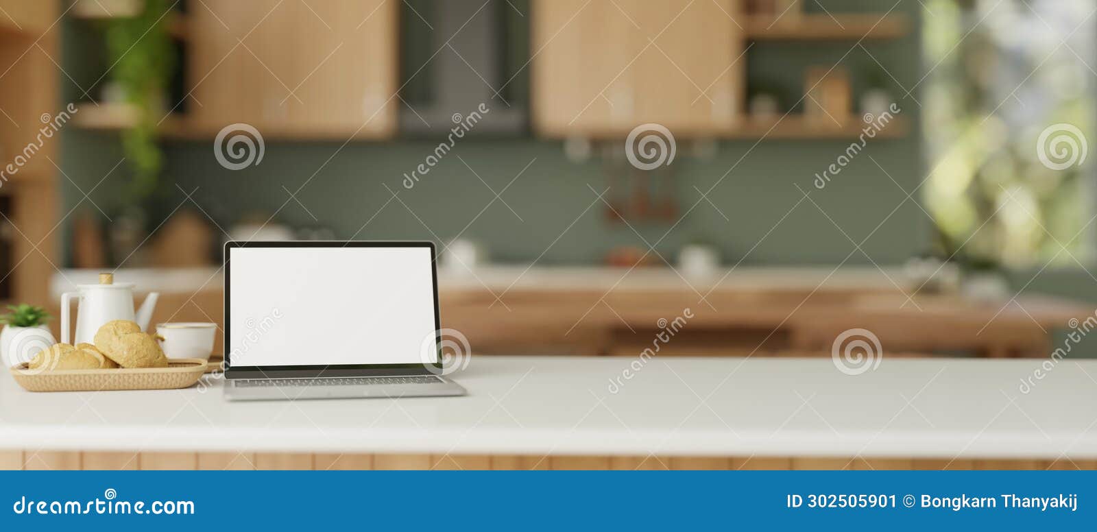A White-screen Laptop Computer on a White Kitchen Tabletop in a Modern ...