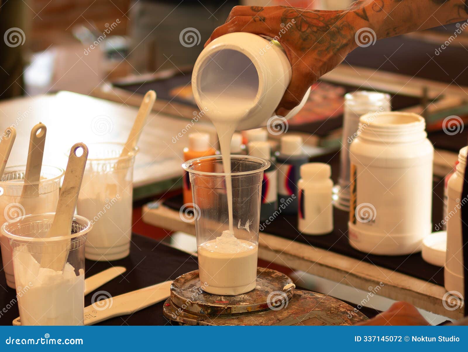 White Screen Printing Ink Poured into a Clear Plastic Cup Stock Photo ...