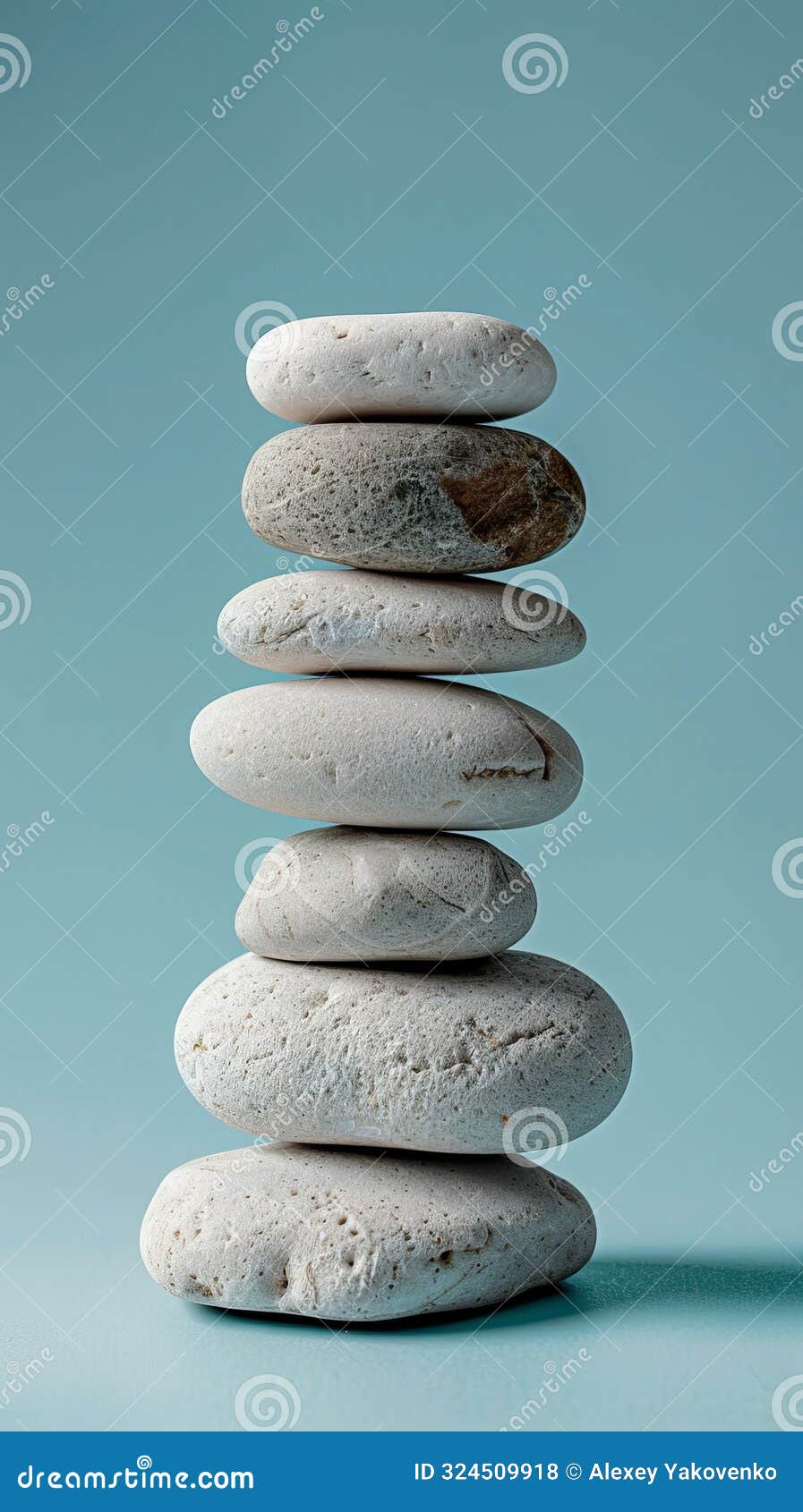 White Sea Pebble Stone Stack on Light Blue Background. Stock Photo ...