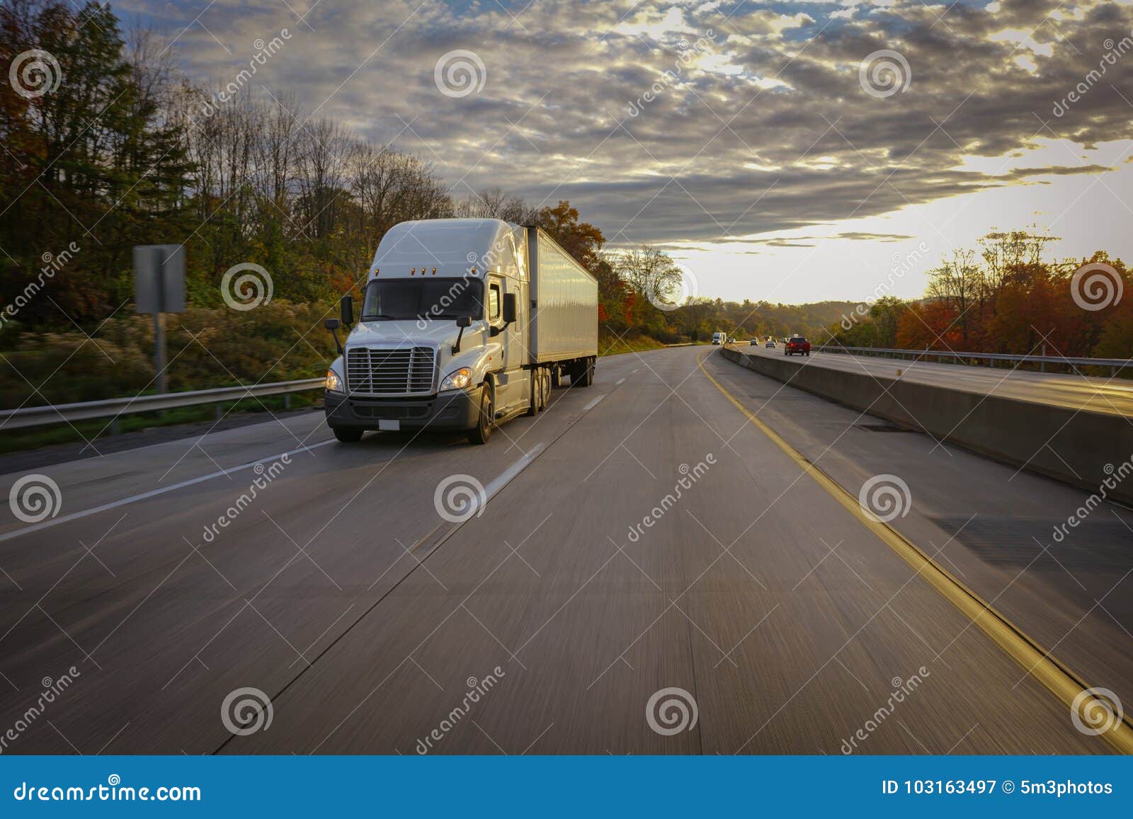 White Big Rig Semi Truck With Dry Van Semi Trailer Driving On The Road ...