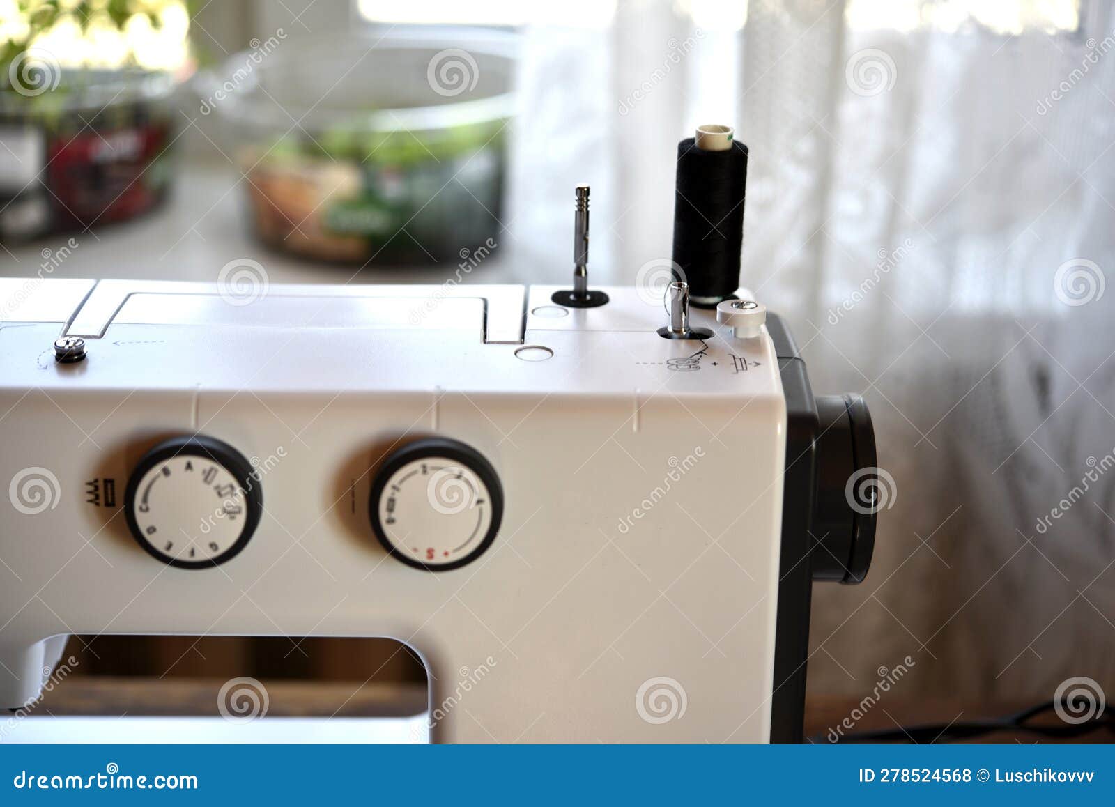 A White Sewing Machine in the Room. Processing of Clothes with a Sewing ...