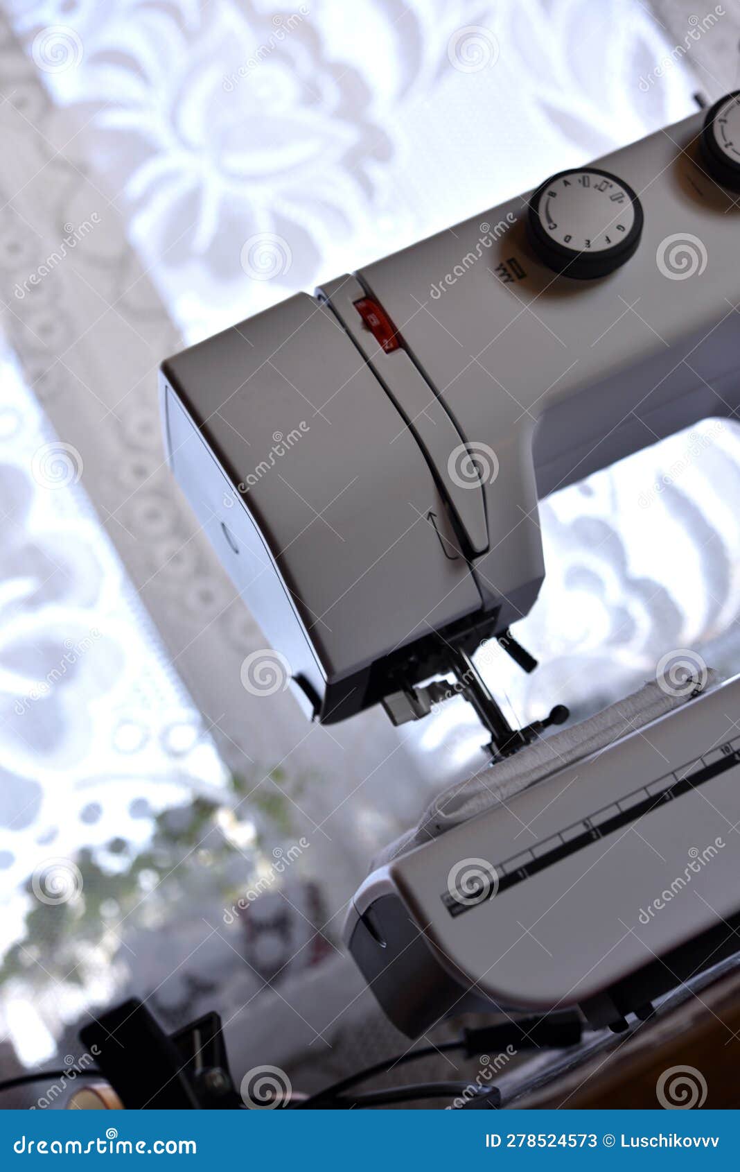 A White Sewing Machine in the Room. Processing of Clothes with a Sewing ...