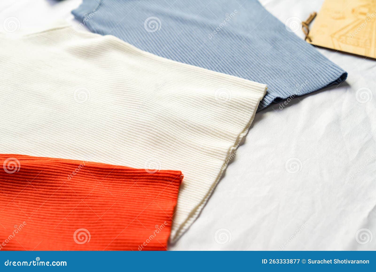 On the White Sheet Were Three Tank Tops, Red, White and Blue ...