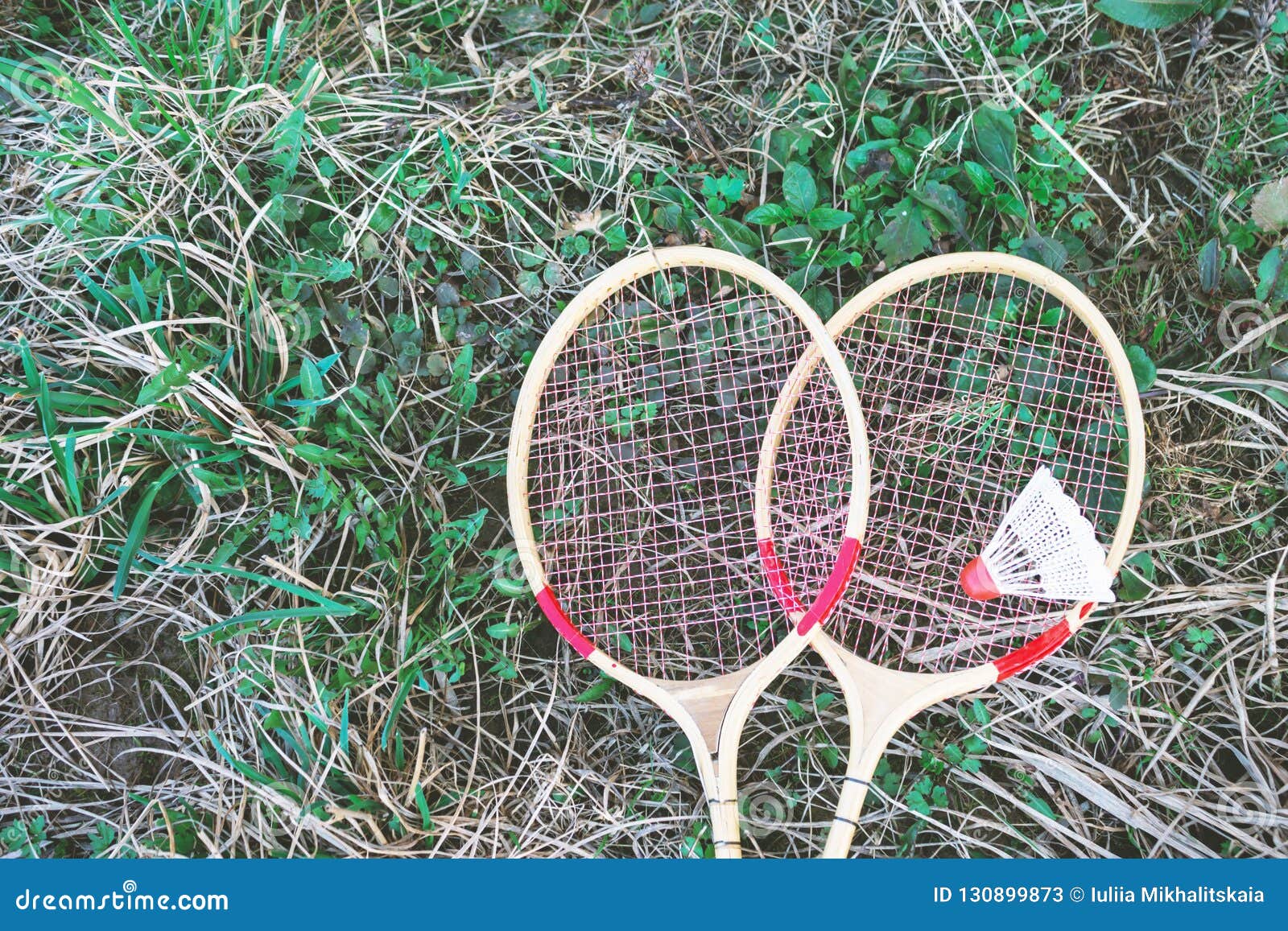 White Shuttlecock and Badminton Racket Lying on Green Grass Stock Image ...