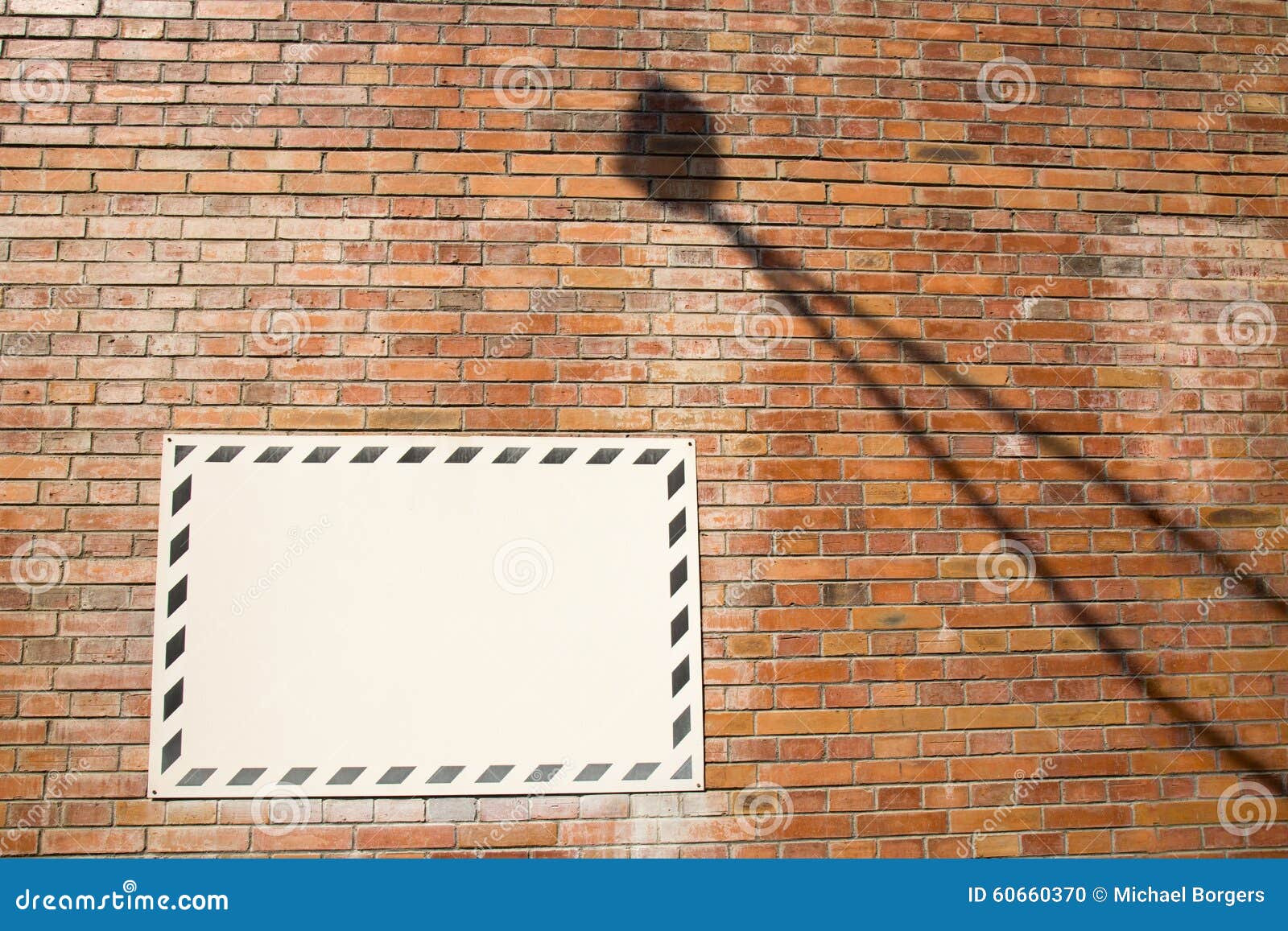 White Sign on Brick Wall with Lamp Shadow Stock Photo - Image of ...