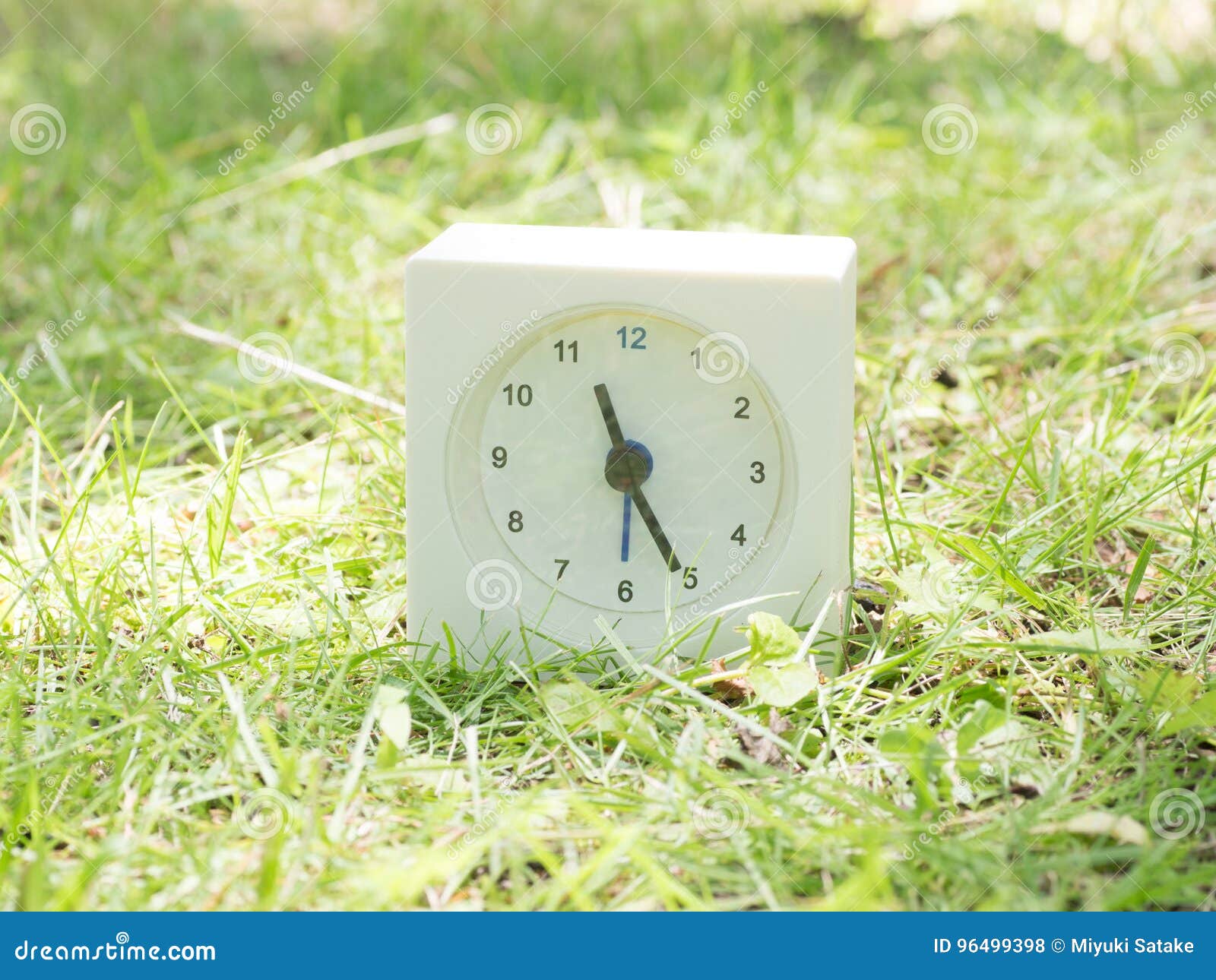 White Simple Clock on Lawn Yard, 11:25 Eleven Twenty Five Stock Photo ...