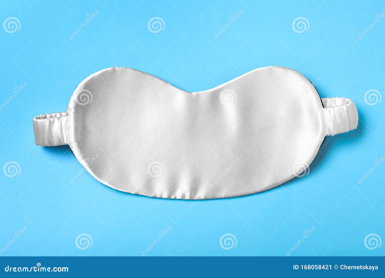 White Sleeping Mask on Light Blue Background. Bedtime Accessory Stock ...