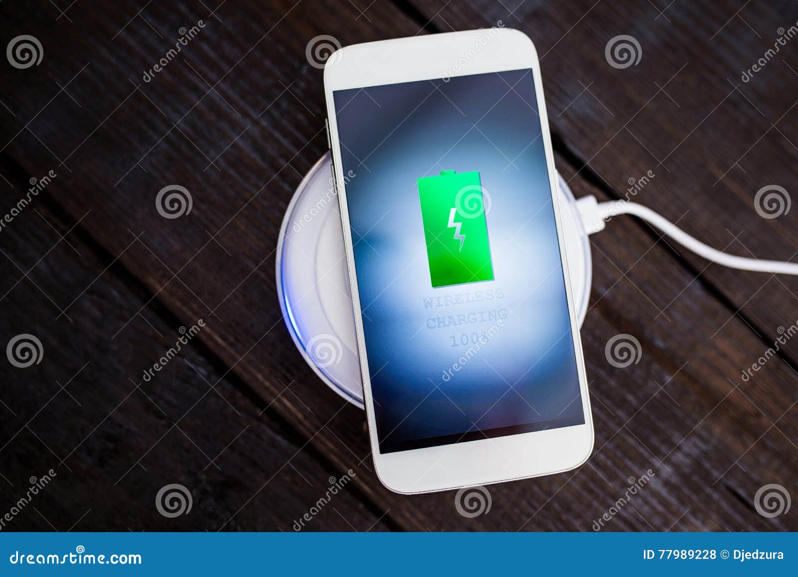 White Smartphone Charging on a Charging Pad. Stock Photo - Image of ...