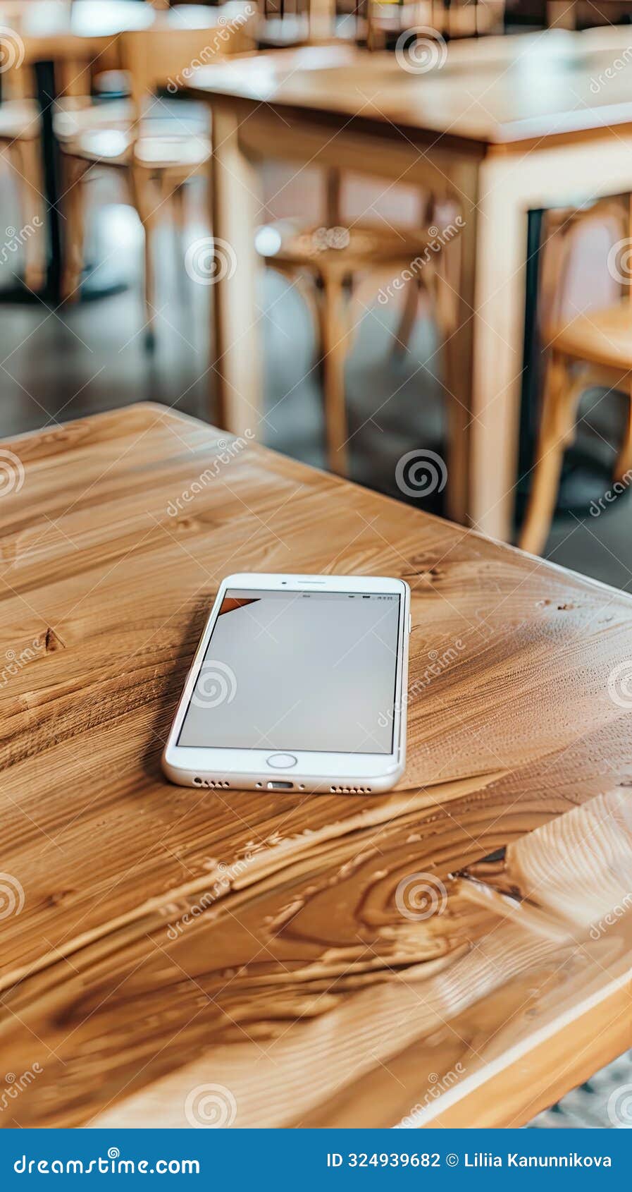 A White Smartphone Rests on a Wooden Table in a Restaurant Setting. the ...