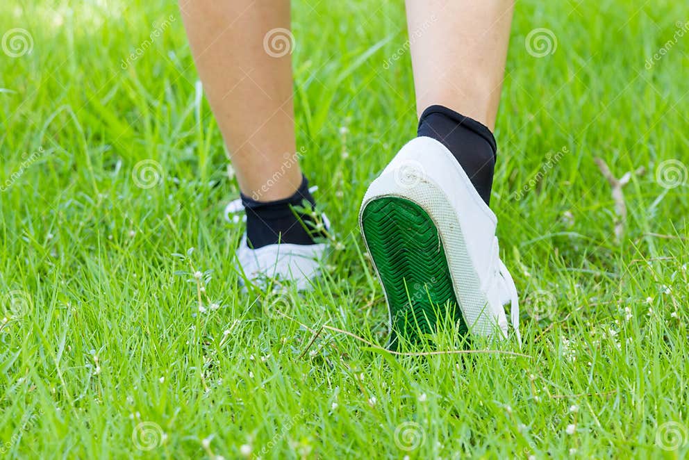 White Sneaker with Step on Grassland Stock Photo - Image of legs ...