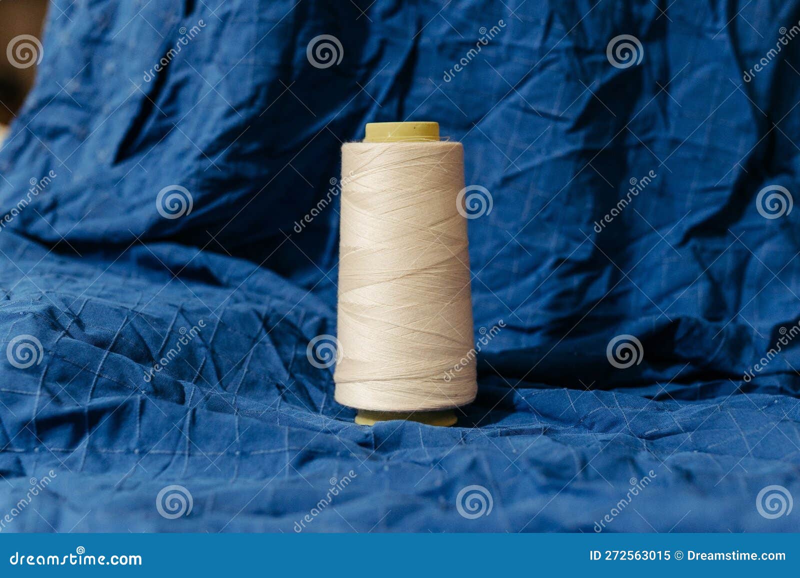 White Spool of Thread Arranged Neatly on a Flat Surface, with Blue ...