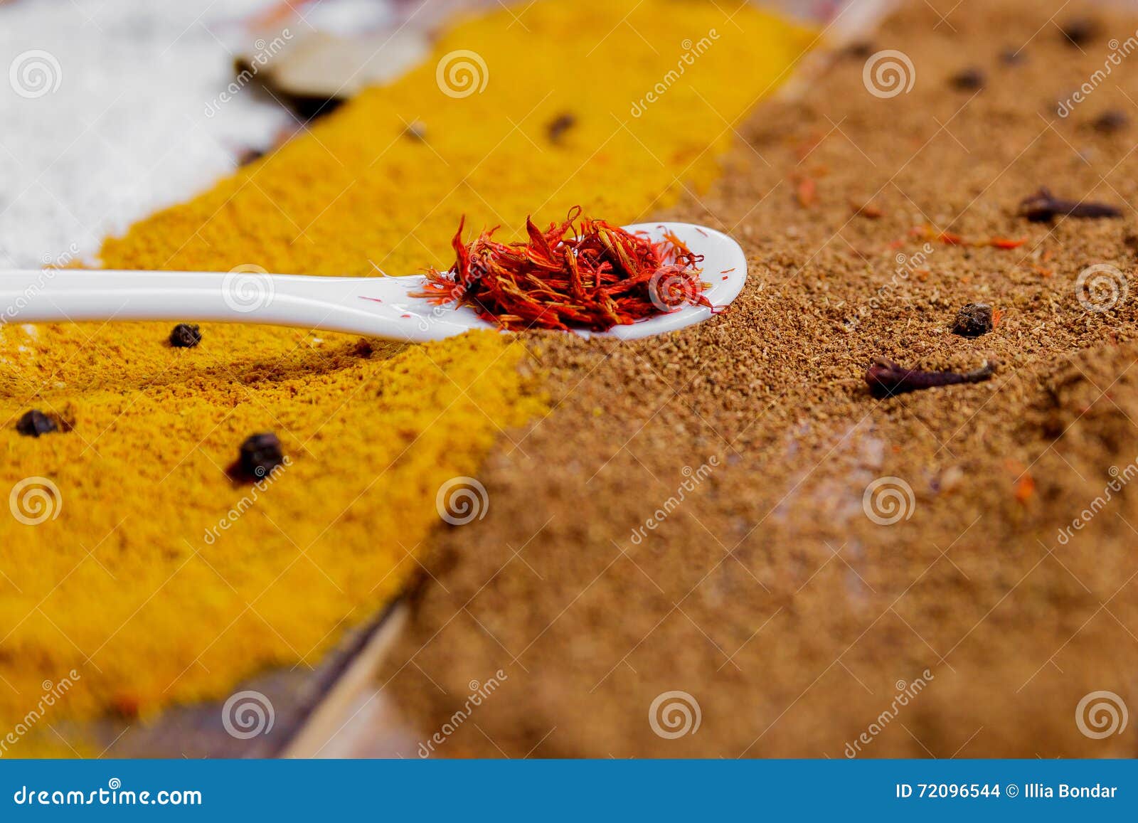 White Spoon with Shafran on Different Colorful Spices Background. Stock ...
