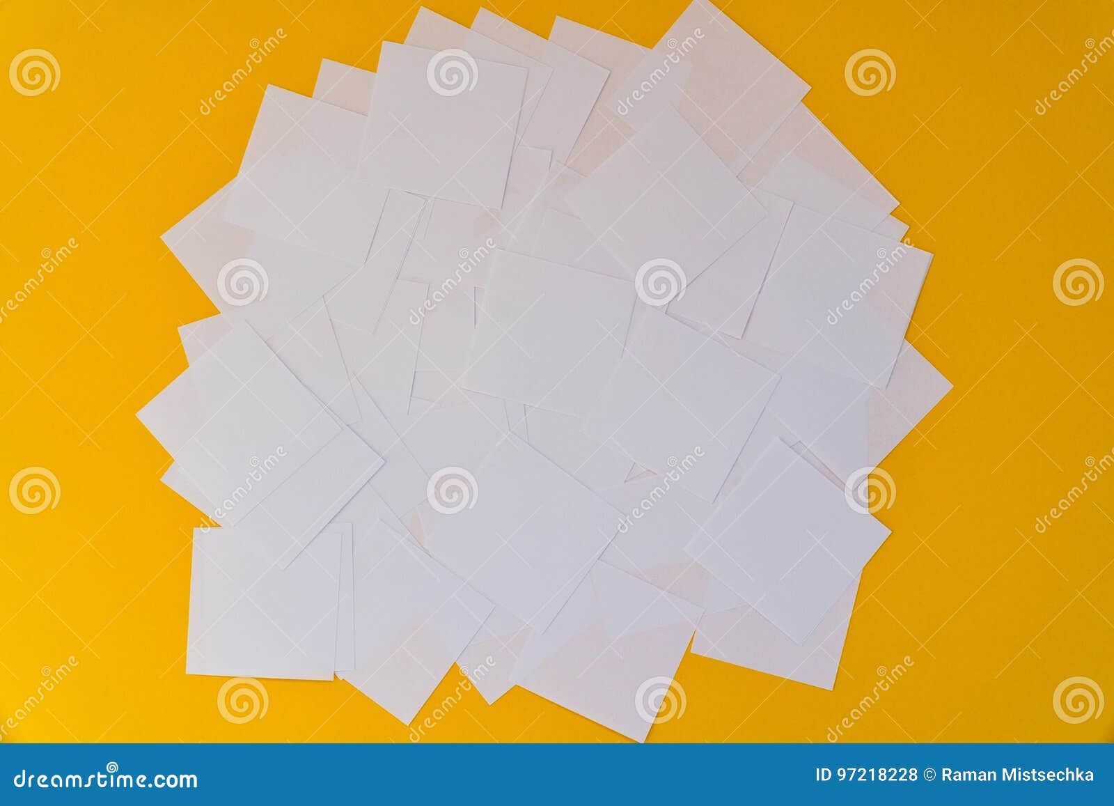 White Square Paper Pieces Spread Out in Chaotic Order on a Yellow ...