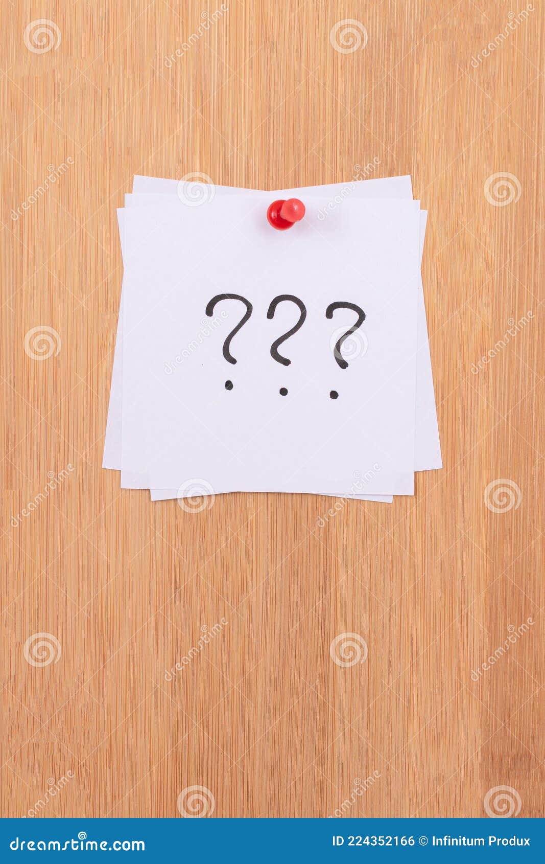 White Sticky Notes with Three Question Marks Pinned To the Wooden ...