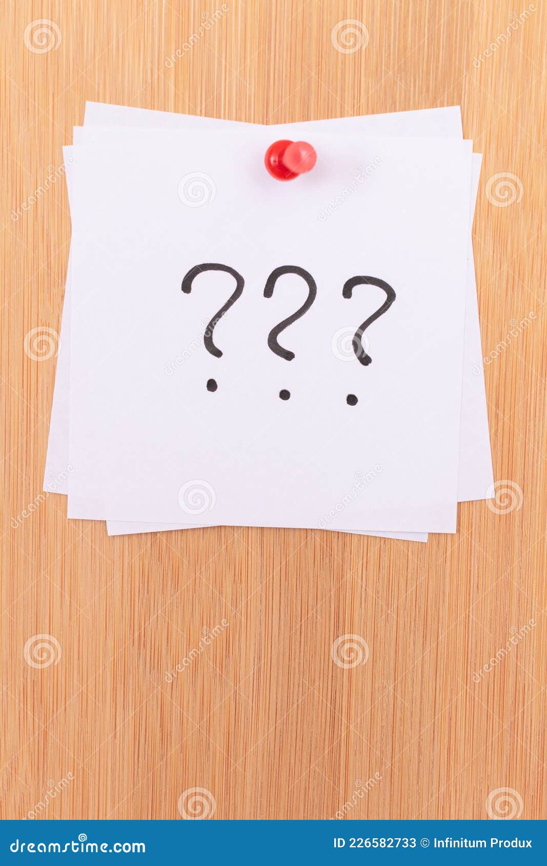 White Sticky Notes with Three Question Marks Pinned To the Wooden ...