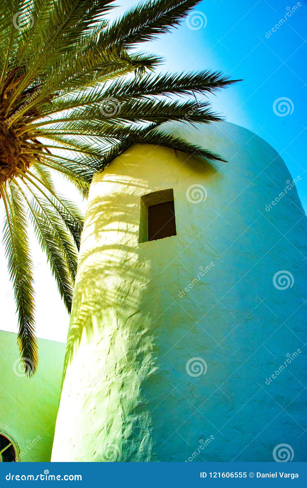 White Stone Tower with a Palm Tree with Blue and Green Colors Effect on ...