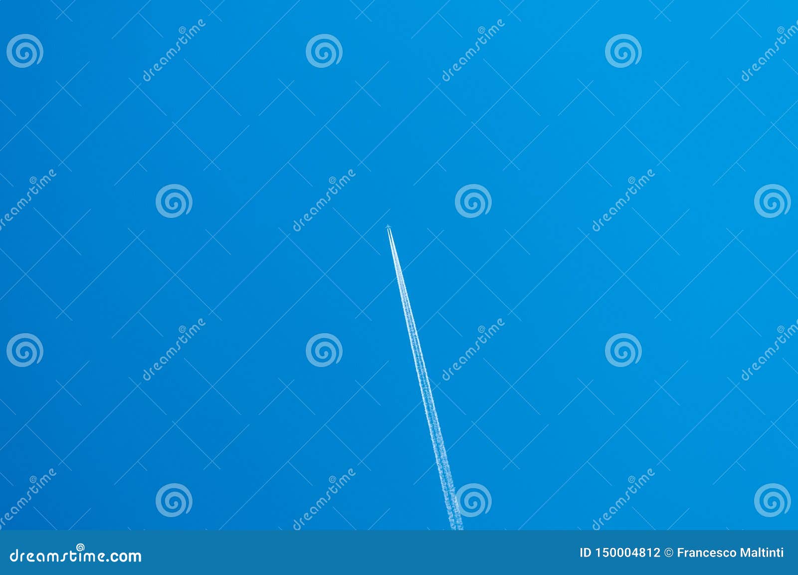 White streaks of a plane stock photo. Image of blue - 150004812