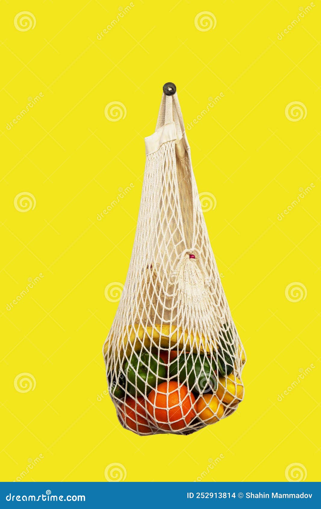 White String Bag with Different Vegetables and Fruits on a Yellow ...