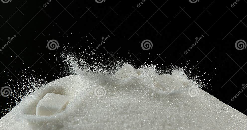 White Sugar Cube Falling on Powder Sugar Against Black Background Stock ...