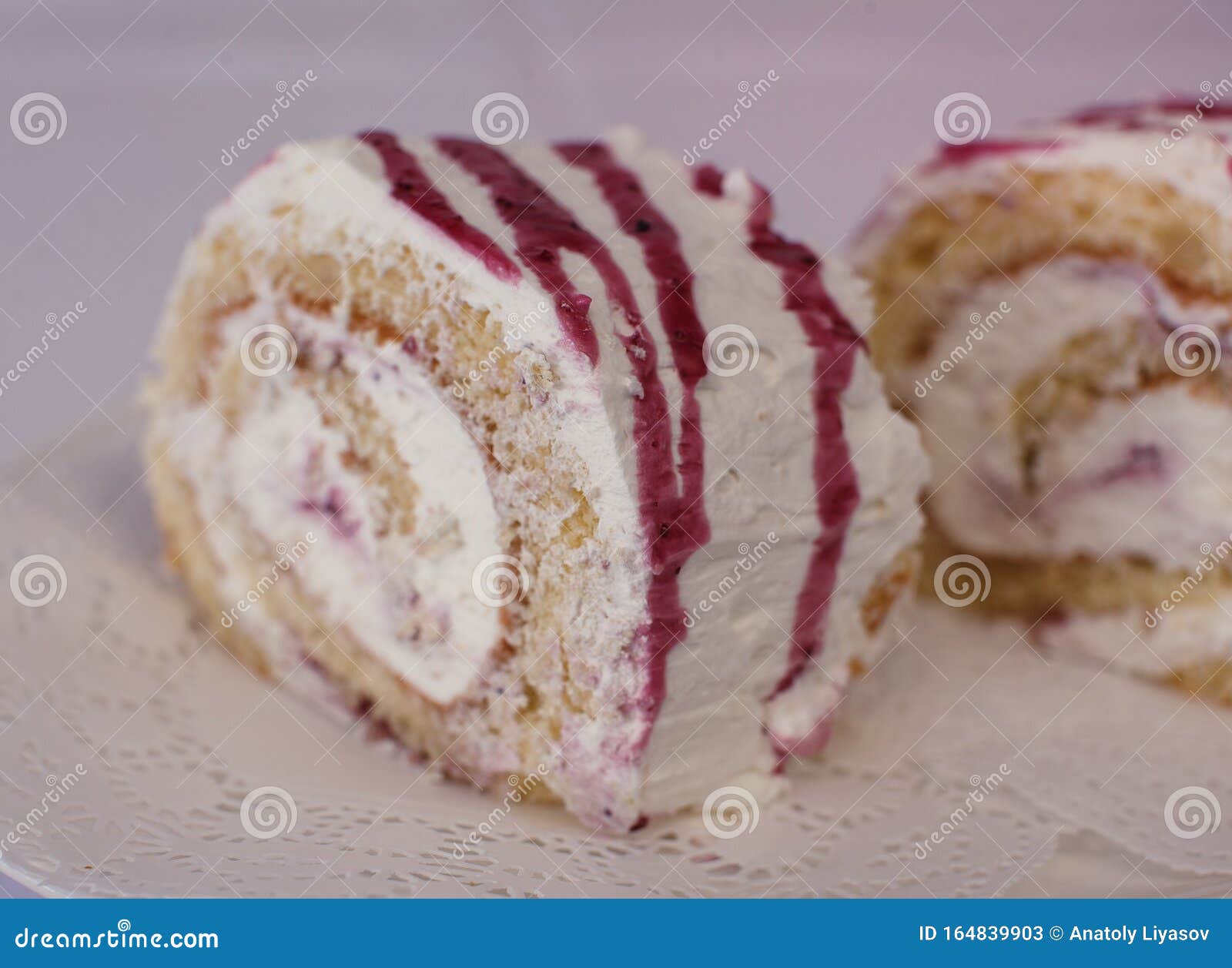 White Swiss Roll Cake with Pink Cream in a Plate Stock Image - Image of ...
