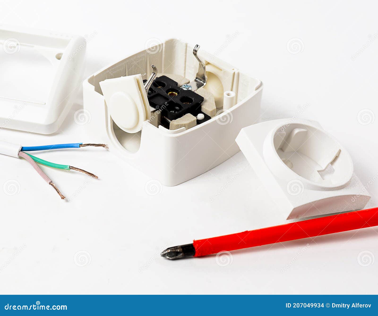 On a White Table, a Disassembled Electrical Outlet Ready To Install ...