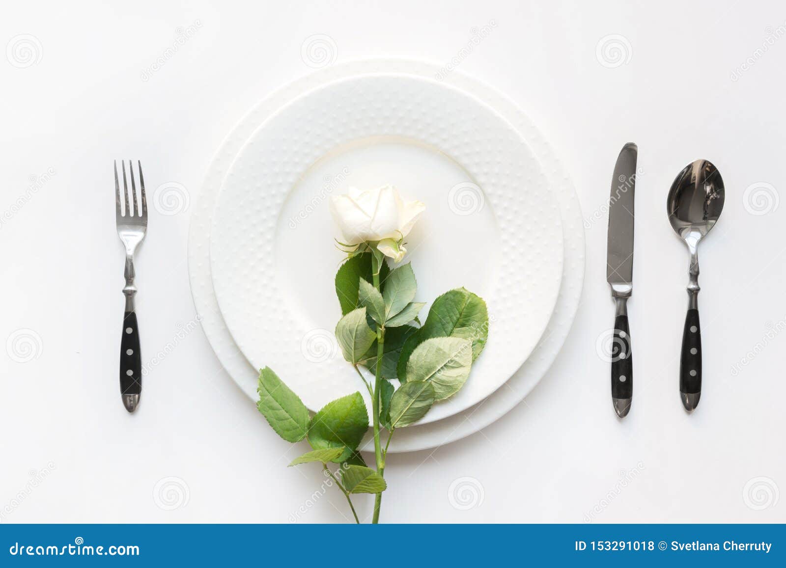 White Table Setting with Bouquet Rose, Gift, Dishware, Silverware on ...