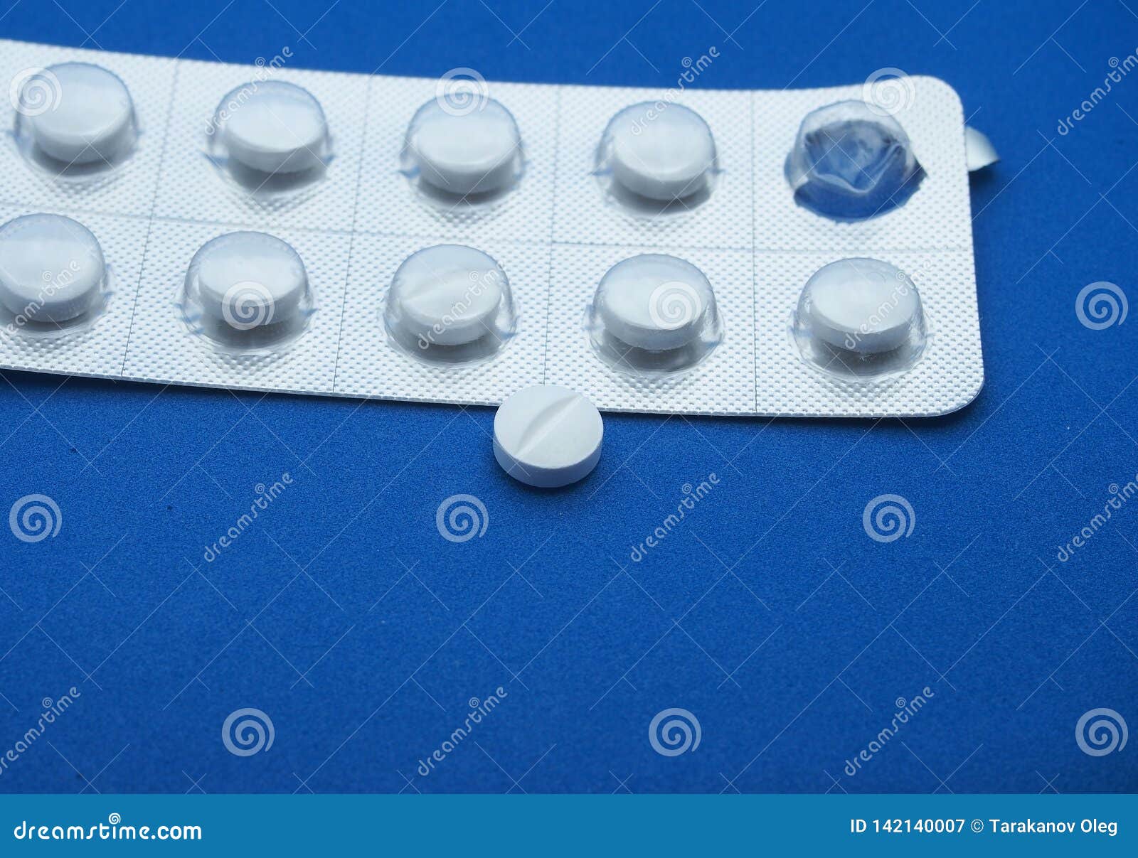 White Tablets on a Blue Background. One Tablet without Packaging, the ...