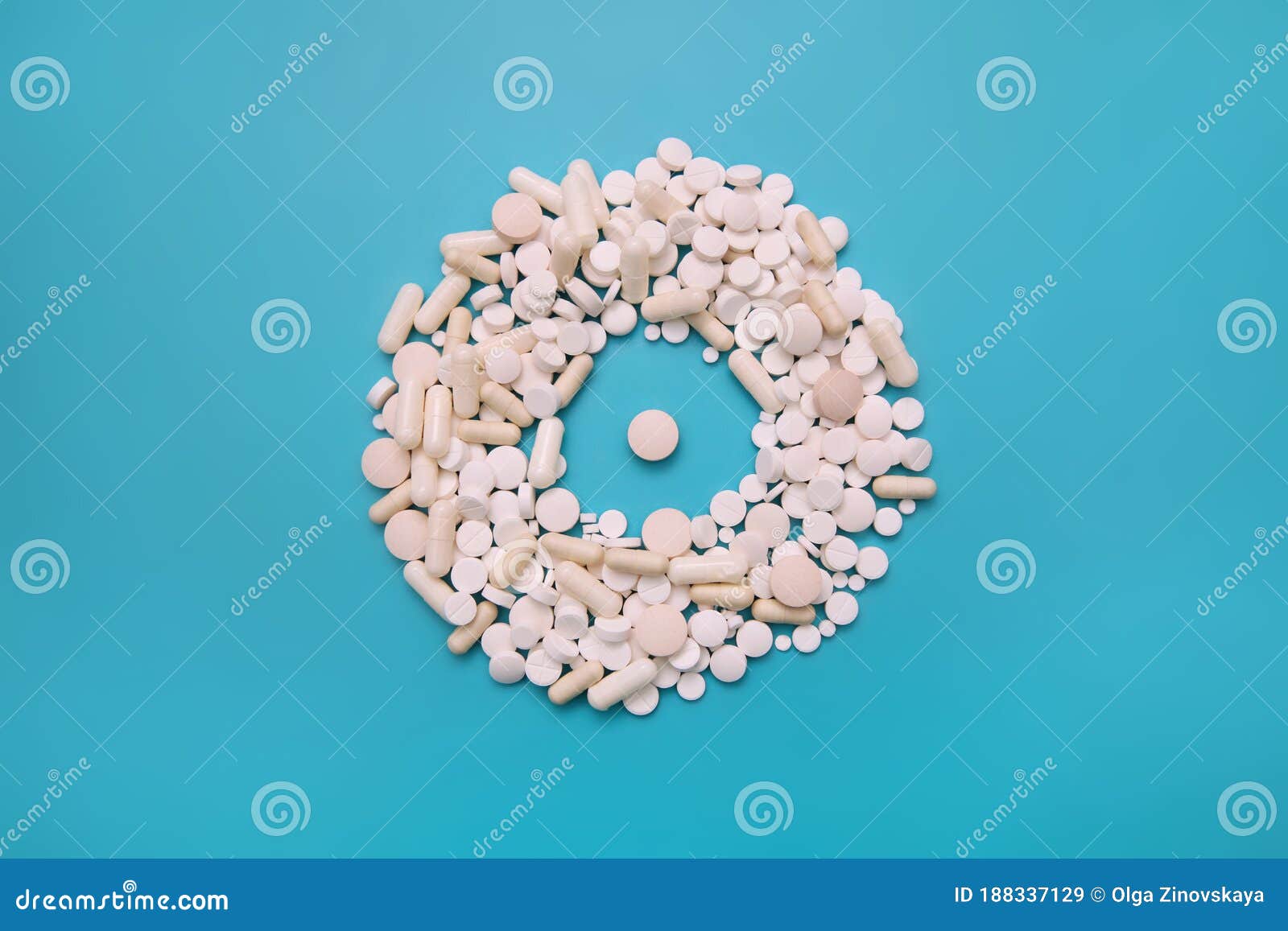 White Tablets and Capsules in the Shape of a Circle on a Turquoise ...