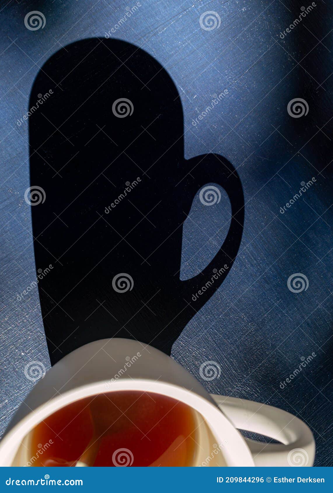 Shadow of a cup of tea stock photo. Image of silhouette - 209844296
