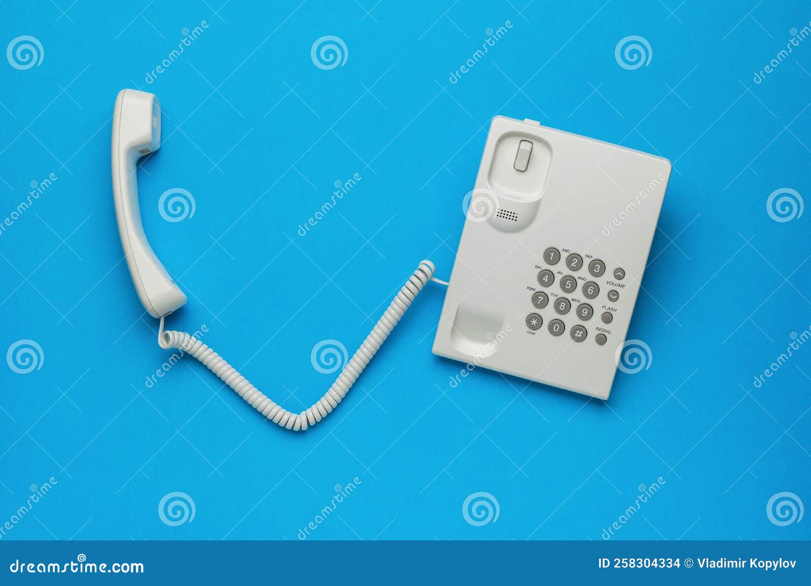 A White Telephone with the Receiver Off on a Blue Background. Flat Lay ...
