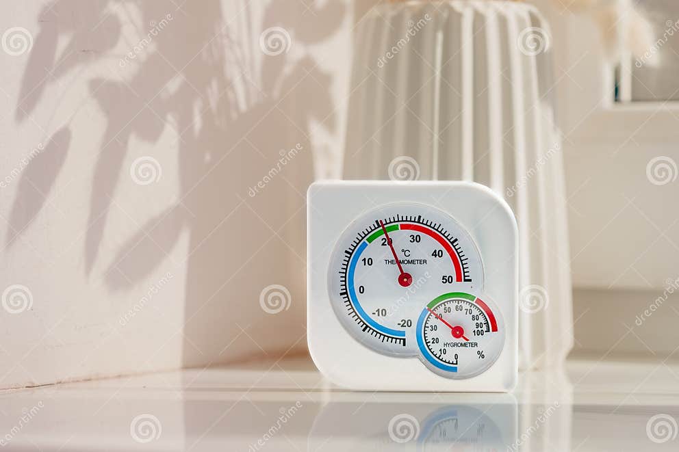 White Thermometer and Hygrometer on a White Surface with a Shadow Stock ...