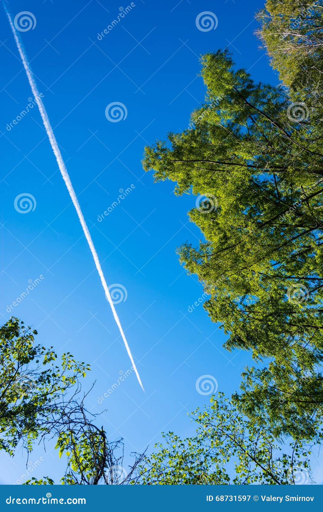White Trace Of Plane Across The Blue Sky. Jet Airplane Is Flying High ...